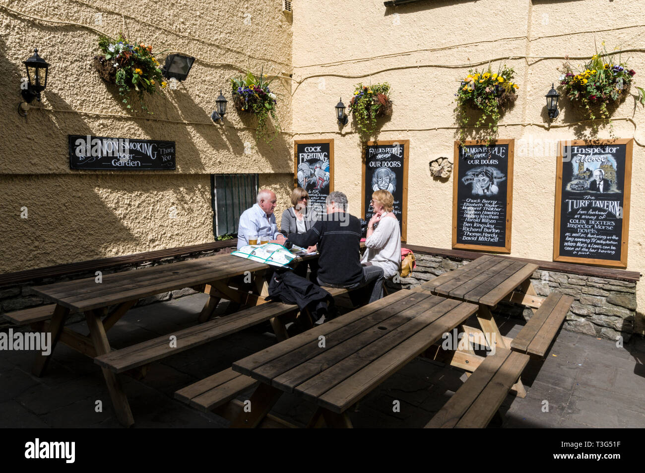Customers having a pint of beer at the Turf Tavern in Oxford, Britain ...