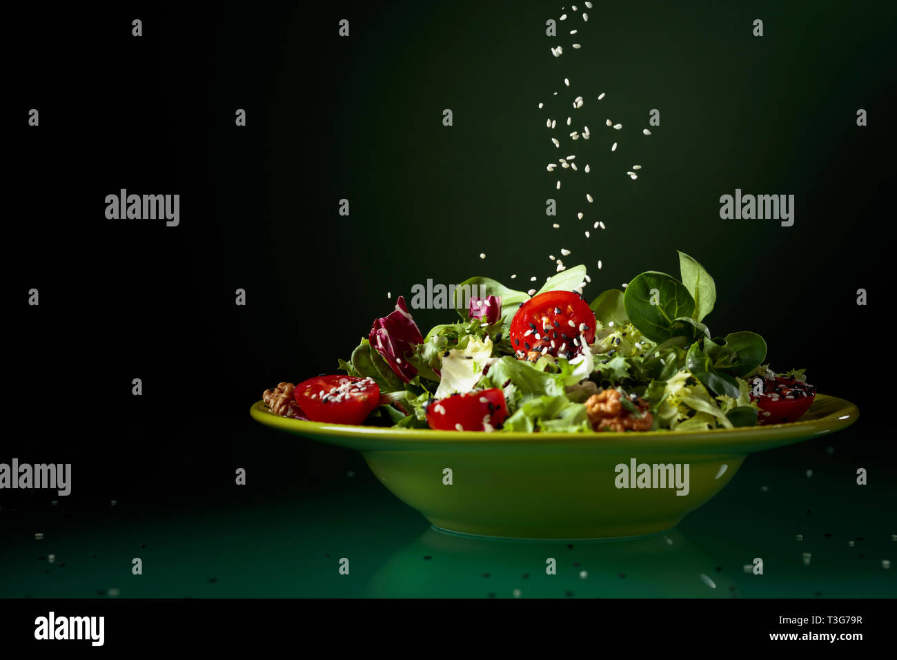 Green salad with cherry tomatoes, walnuts and vegetable oil sprinkle ...