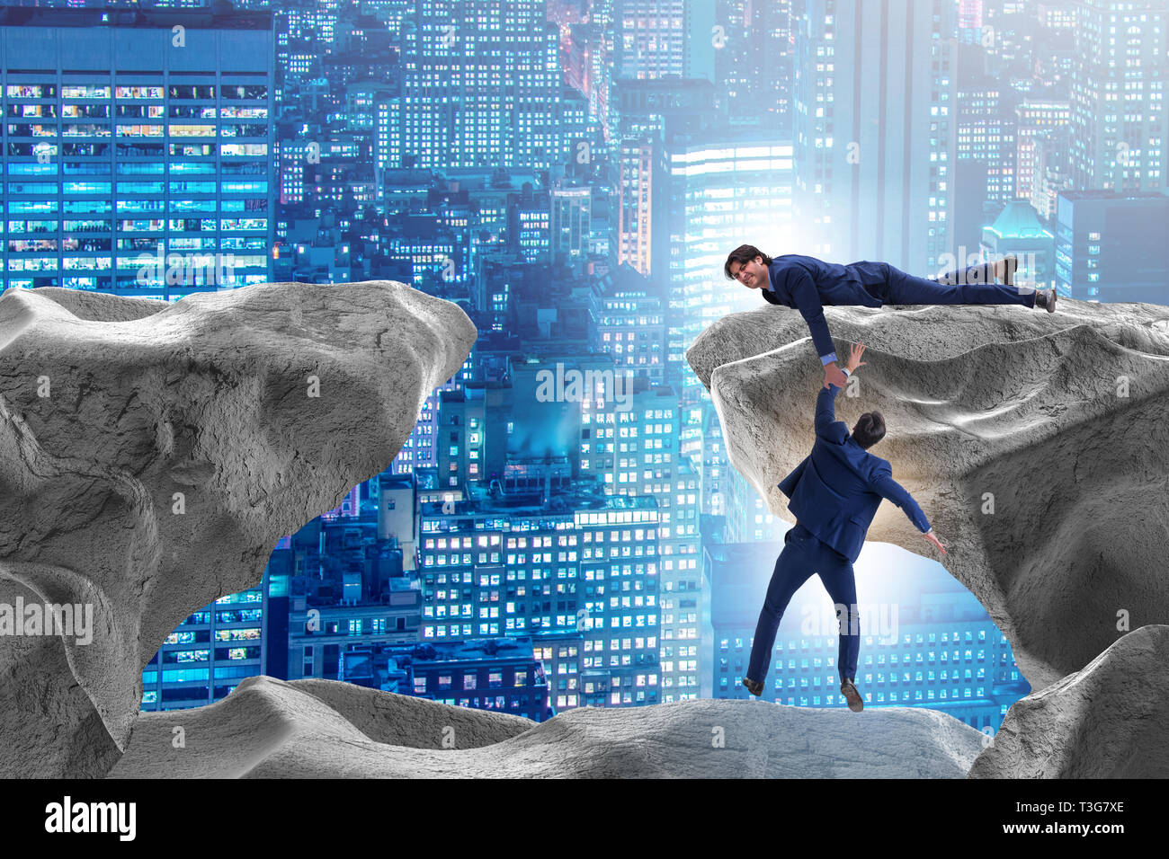 Businessman offering helping hand to falling colleague Stock Photo - Alamy