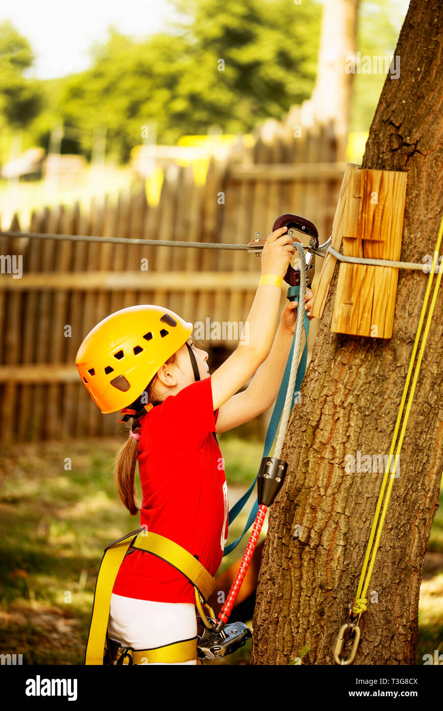 Little brave caucasian girl treerunner fasten the rollclip before ...