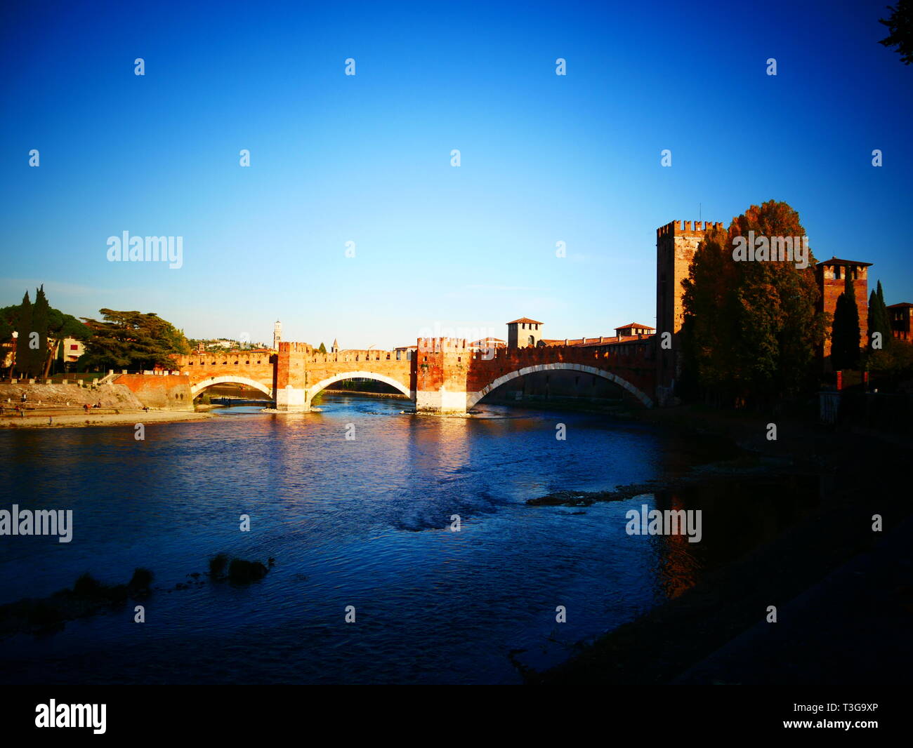Romantic bridge over blue river Stock Photo - Alamy