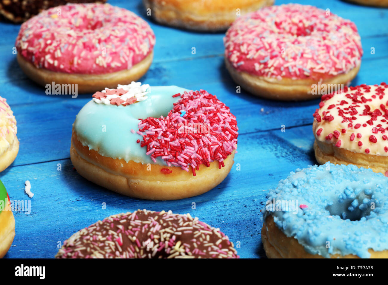 assorted donuts with chocolate frosted, pink glazed and sprinkles ...