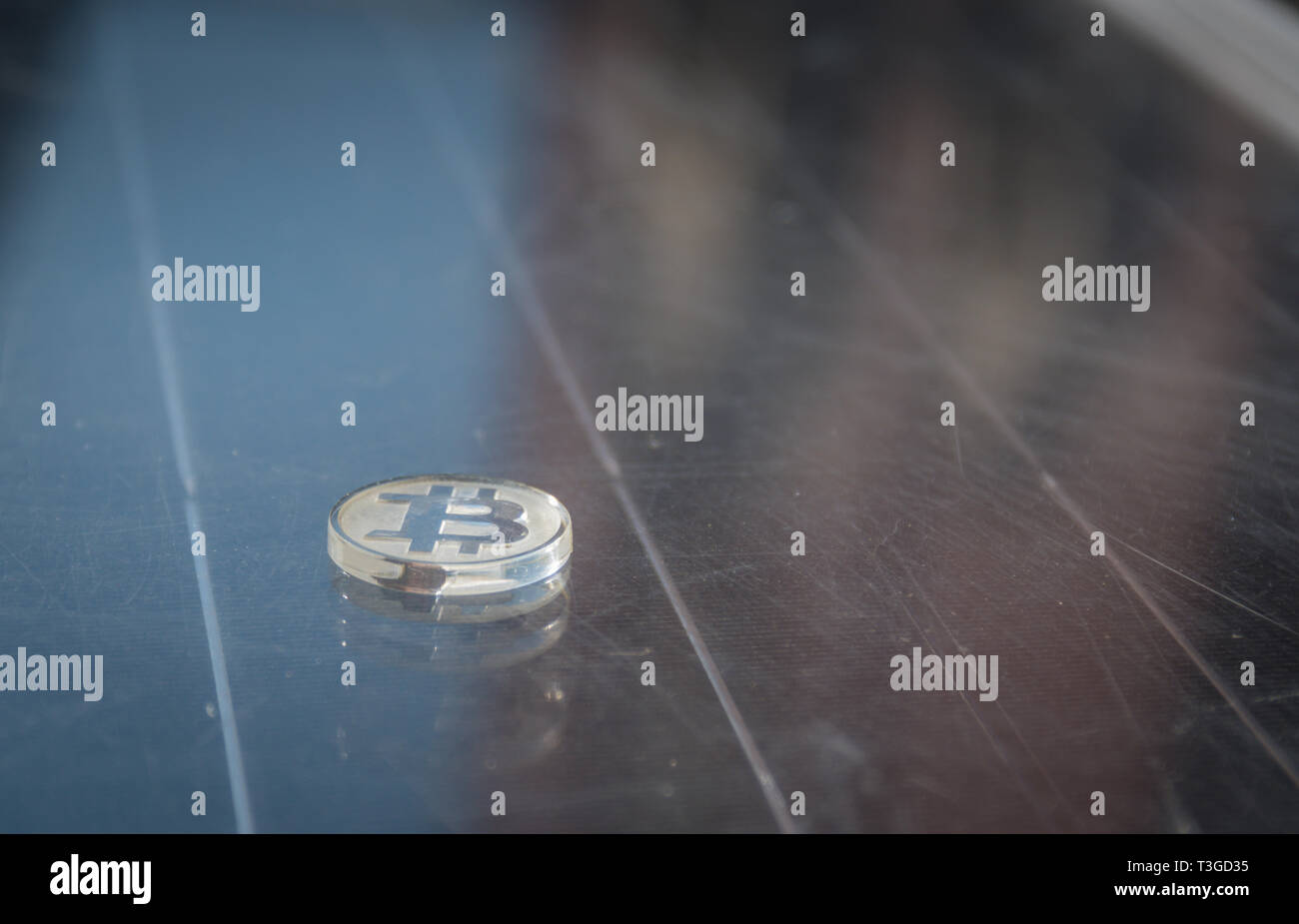 Clear plastic custom bit coin in nature Stock Photo - Alamy