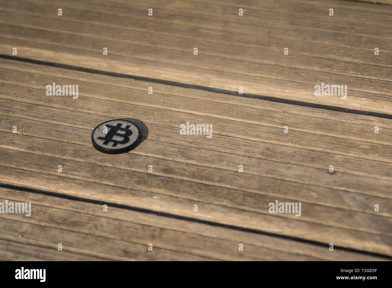 Made from black plastic custom bit coin on rustic old background Stock ...