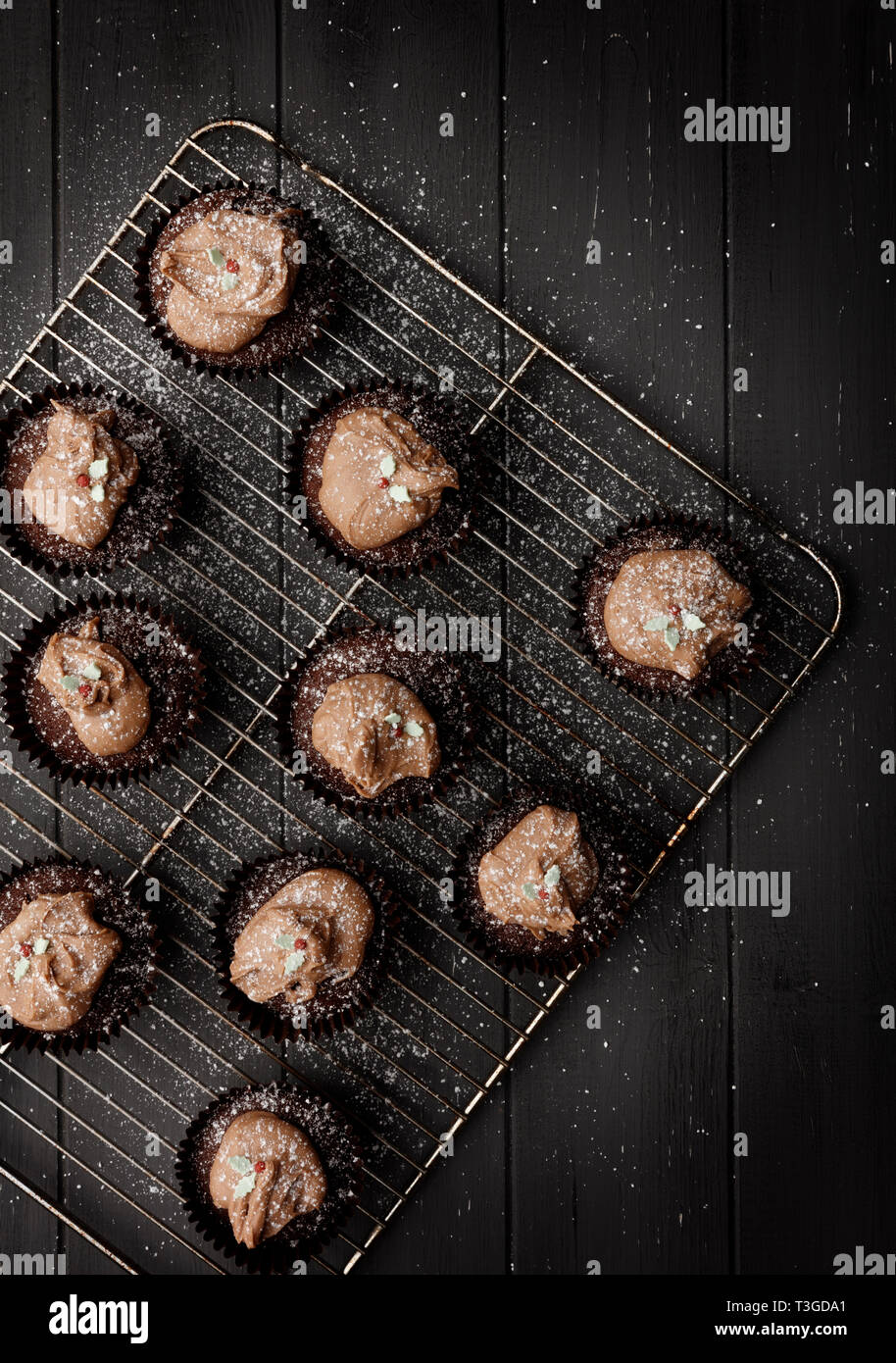 Fairy cakes on a cooling tray with sprinckled icing sugar on a ...