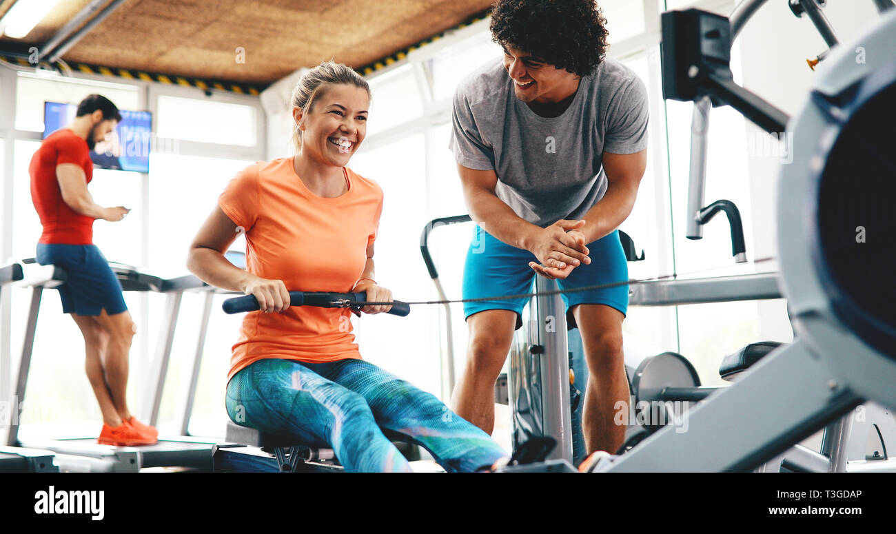 Personal trainer helping young woman reach goals Stock Photo - Alamy