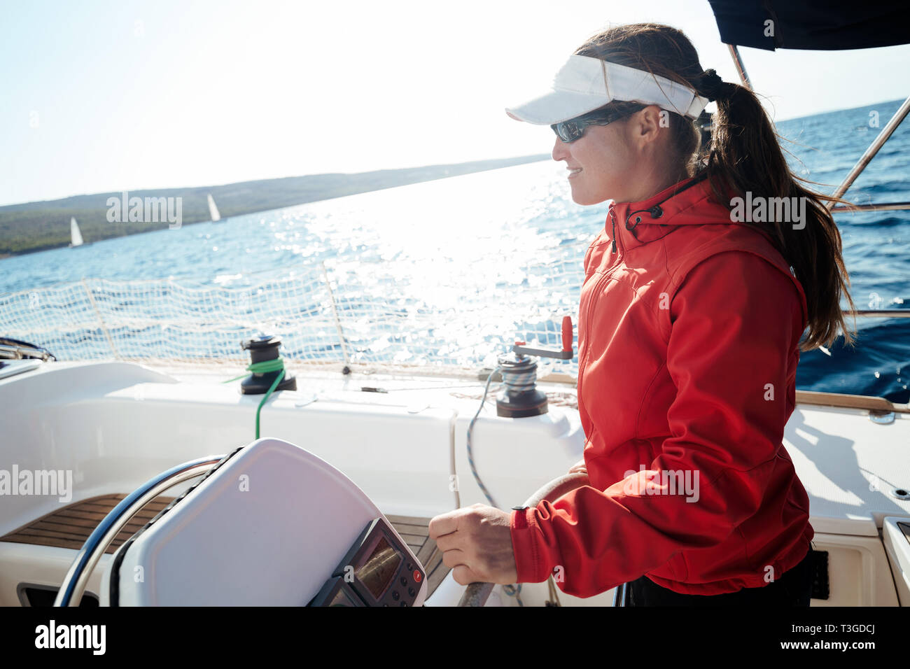 Attractive strong woman sailing with her boat Stock Photo - Alamy
