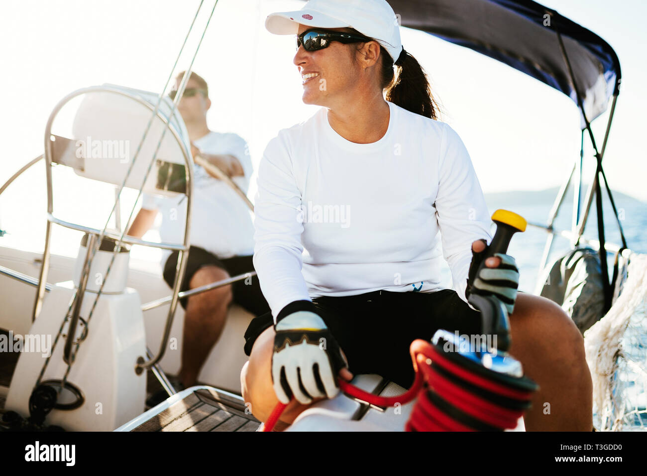 Attractive strong woman sailing with her boat Stock Photo - Alamy