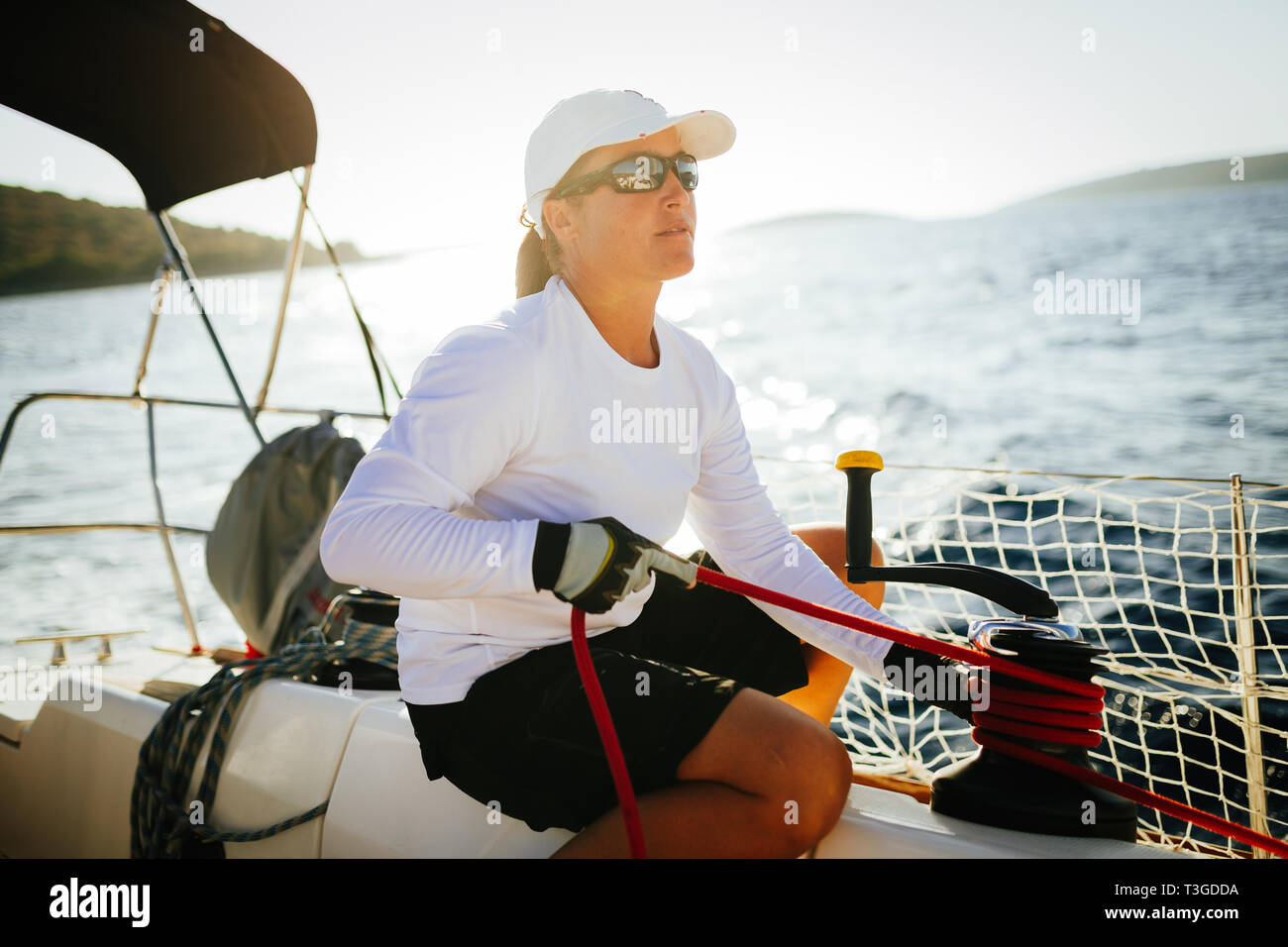 Attractive strong woman sailing with her boat Stock Photo - Alamy