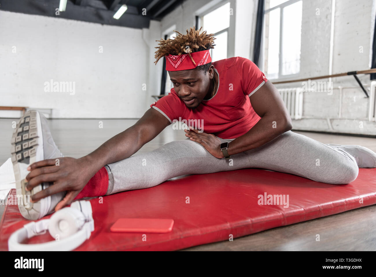 Strong insistent dark-skinned man having sportive training Stock Photo ...