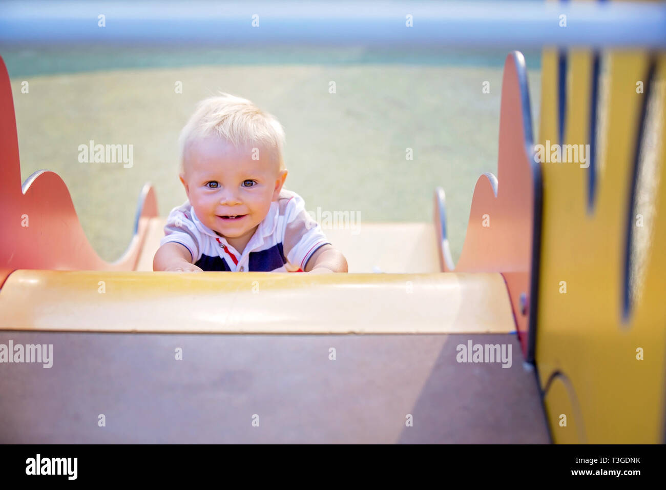 Little baby boy, playing on playground on sunset, summertime Stock ...