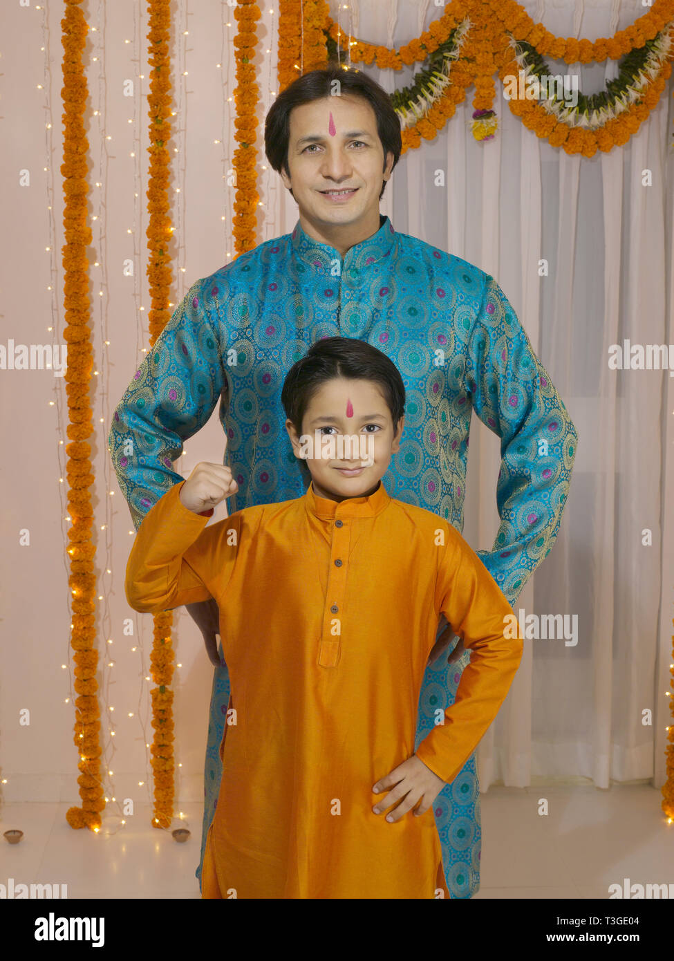 PORTRAIT OF AN INDIAN FATHER AND SON CELEBRATING THE FESTIVAL OF DIWALI ...