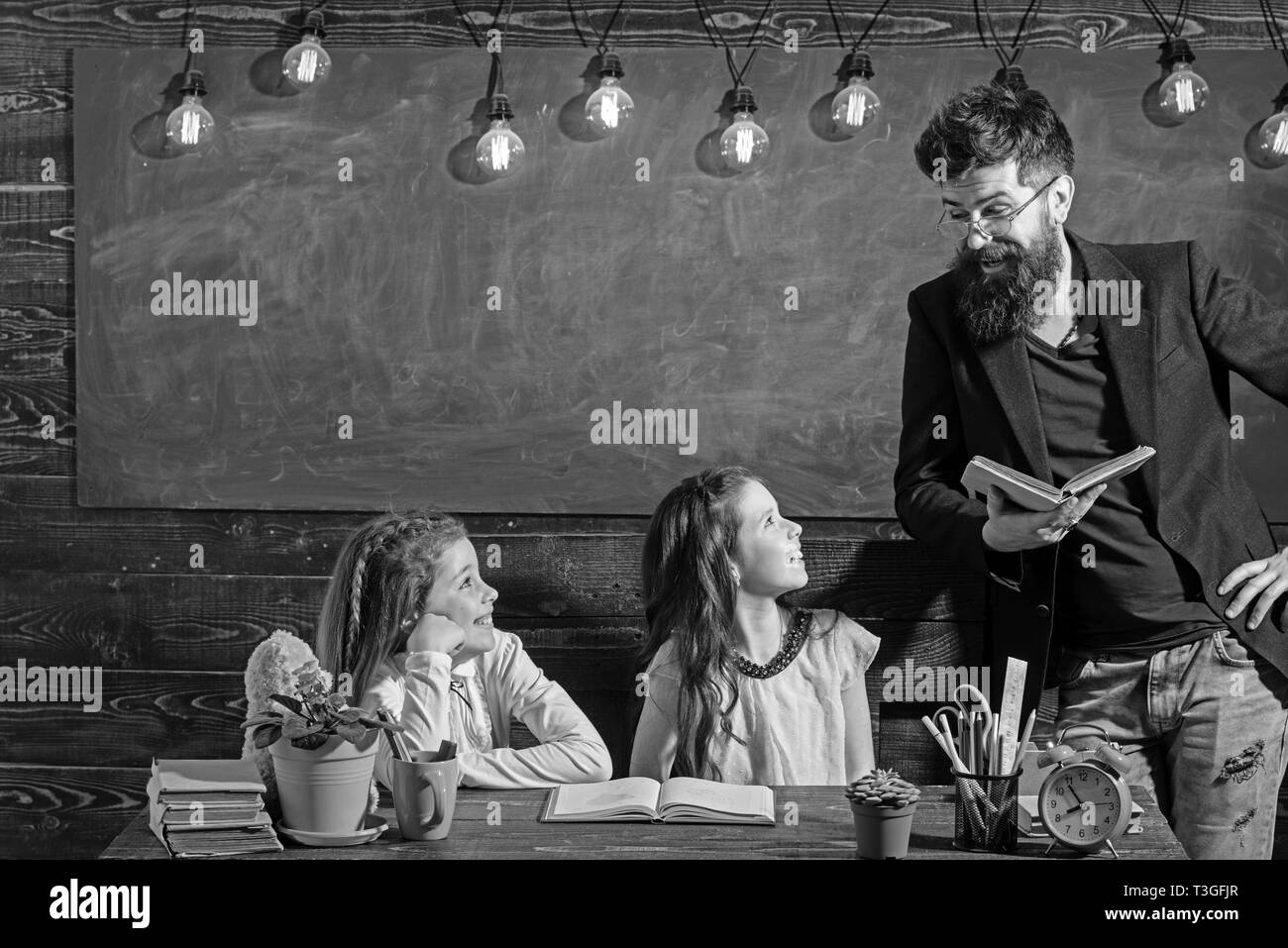 Teacher helping students in it class Black and White Stock Photos ...
