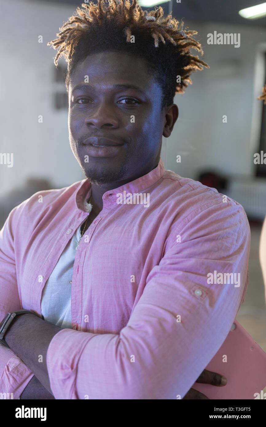 Resolute handsome man standing with crossed hands and looking directly ...