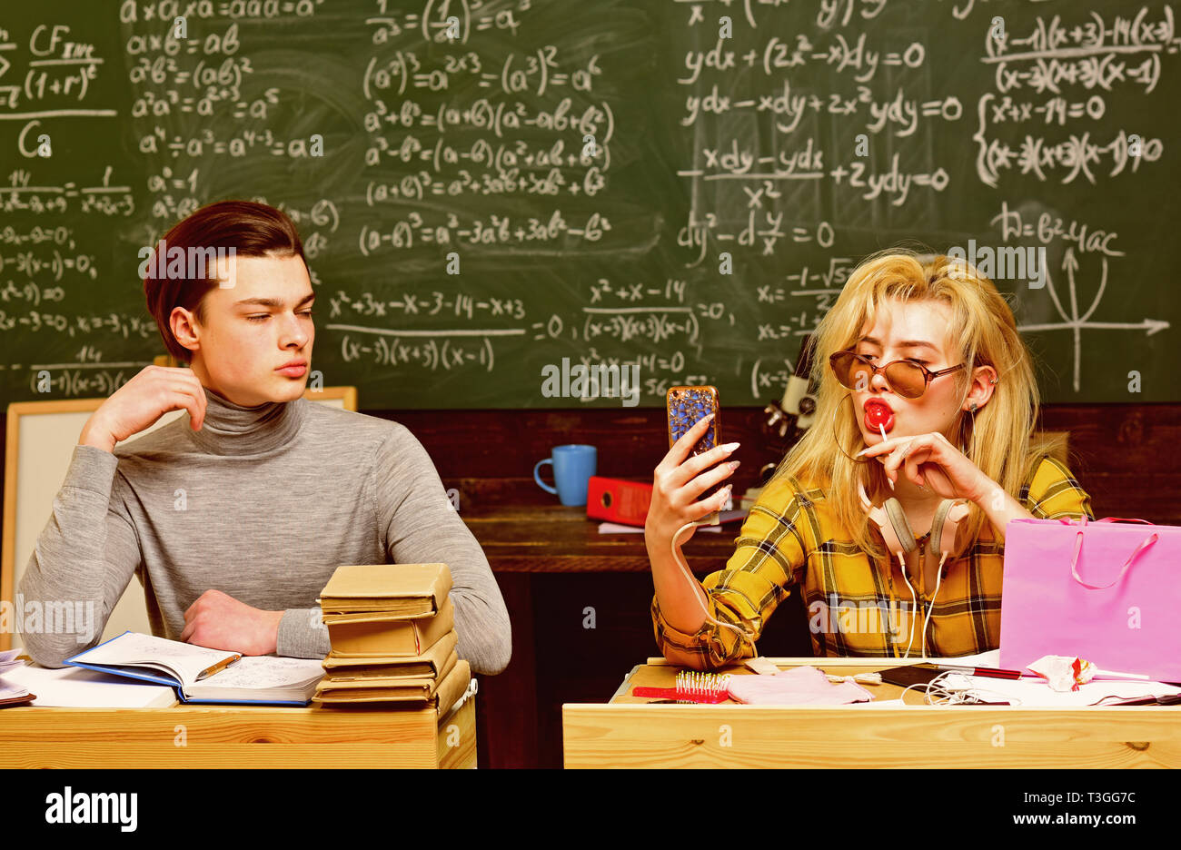 University studying friends studying and reading a books in classroom ...