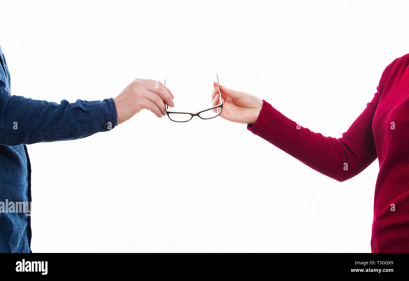 Man giving glasses to a young woman over white background. Oculist ...