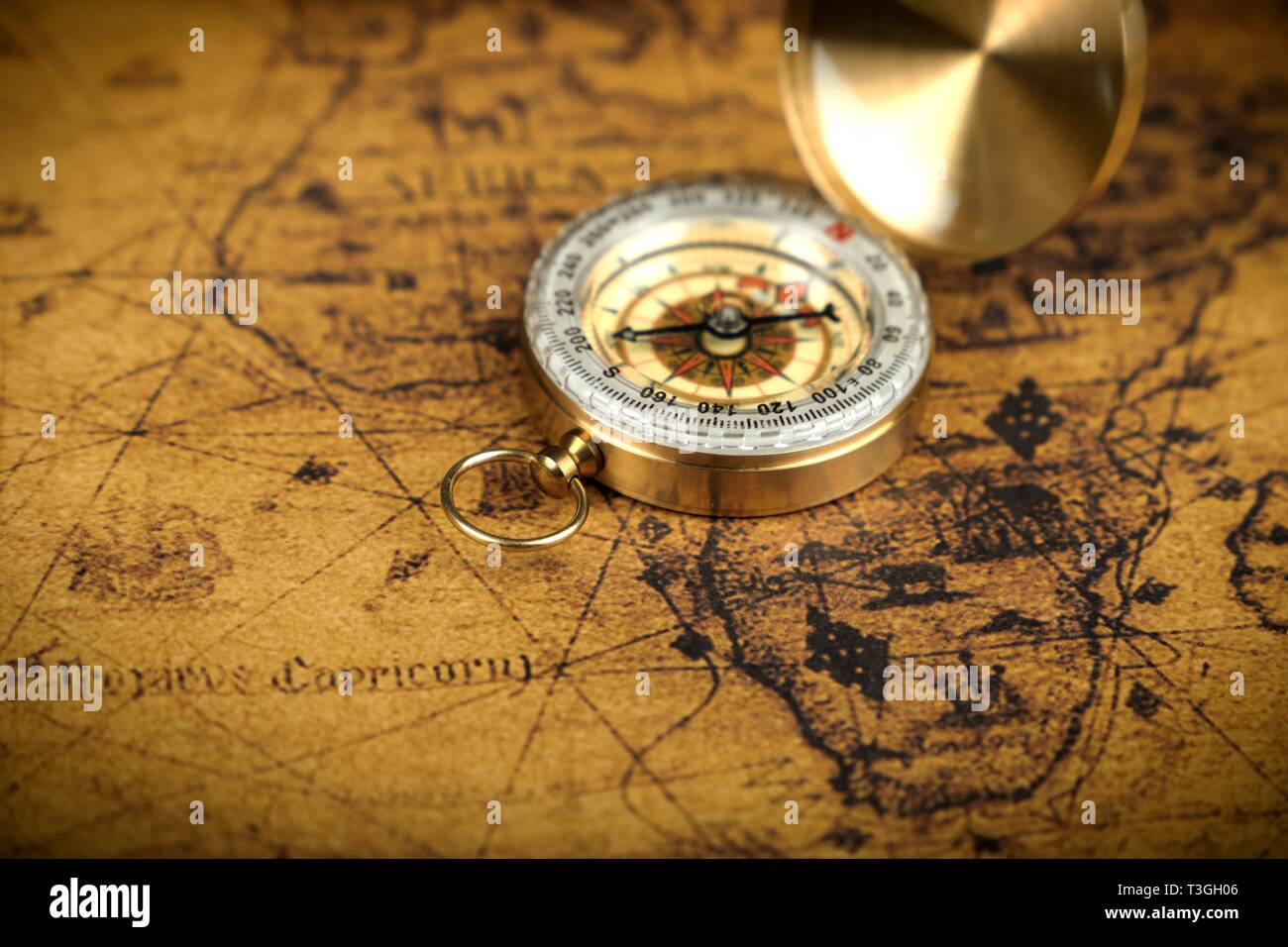 Vintage Compass lies on an ancient world map - adventure stories ...