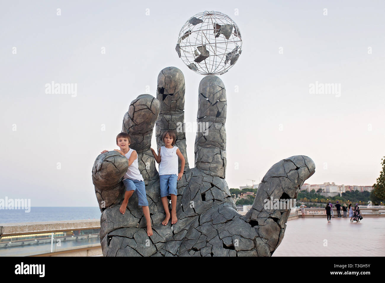 Two boys enjoying the city of Monaco in the evening, having fun ...