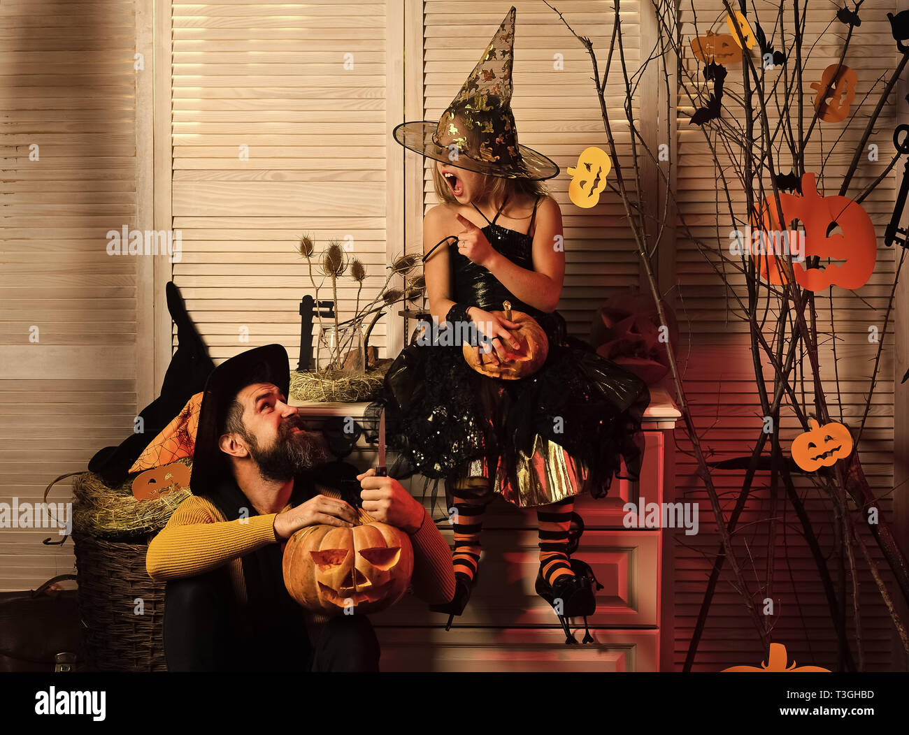 Father and daughter with Halloween decor. Wizard and little witch Stock ...