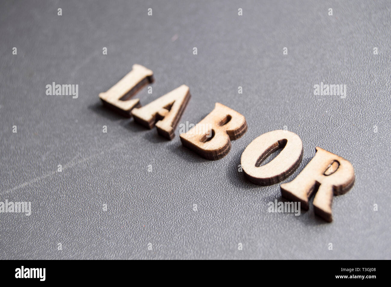 The word work written with wooden letters on a gray background, the ...