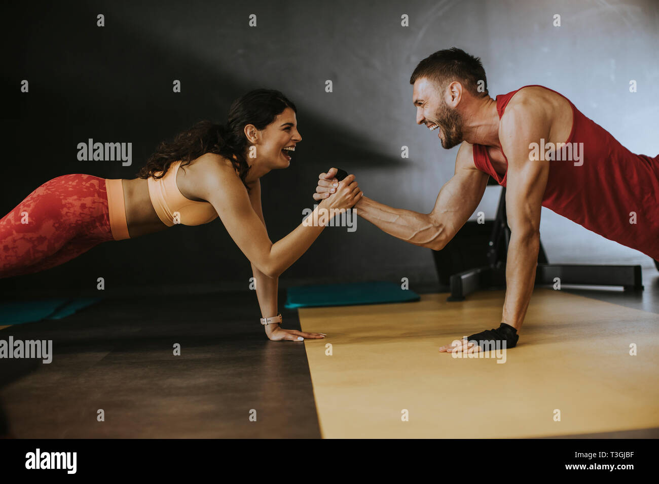 Fit sportive man and woman doing plank core exercise in the gym Stock ...