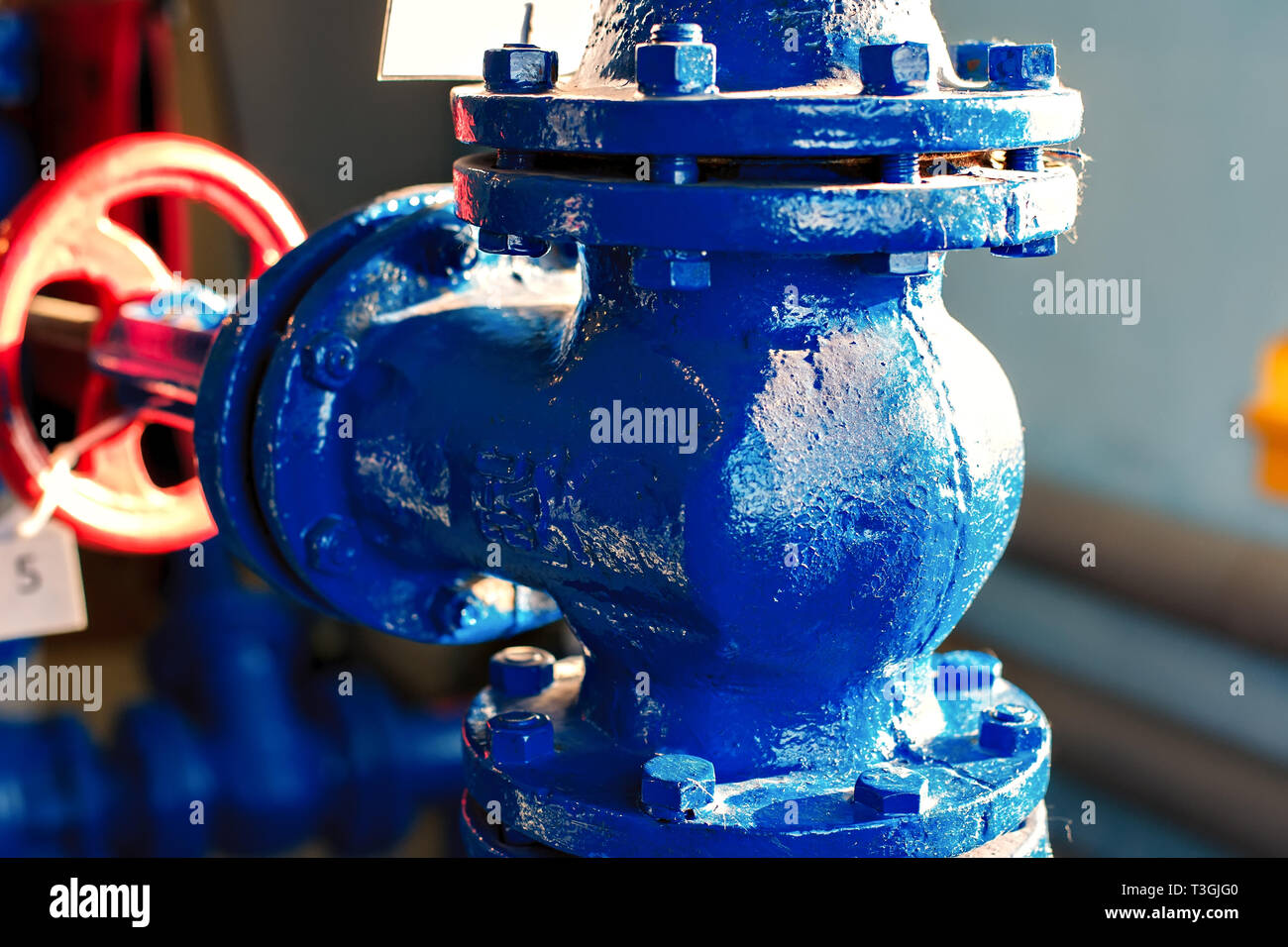 Large diameter gas pipe tee close-up with a red valve on the end in the ...