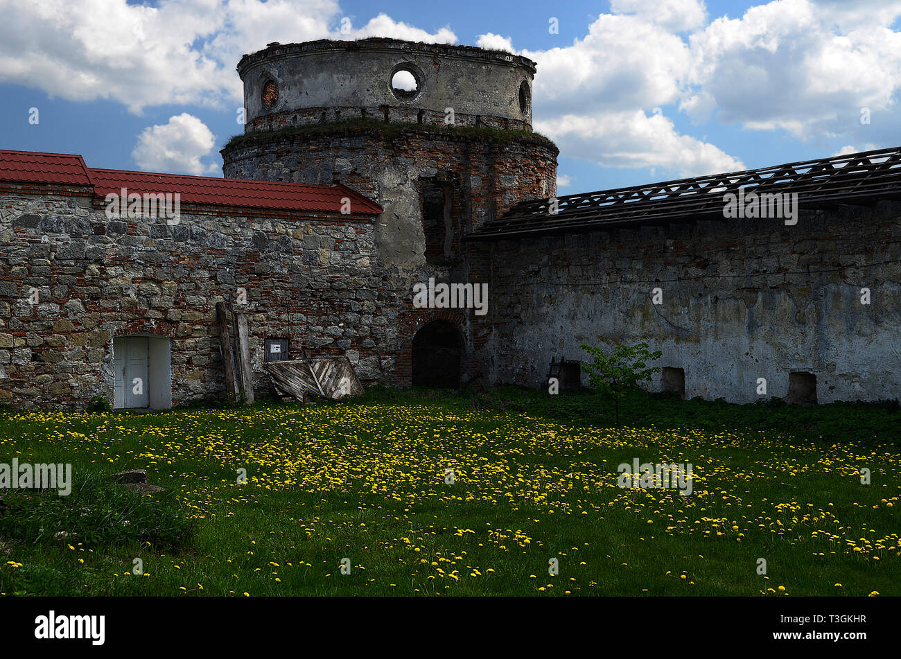 The stone walls of the ancient castle on a background of blue sky and ...