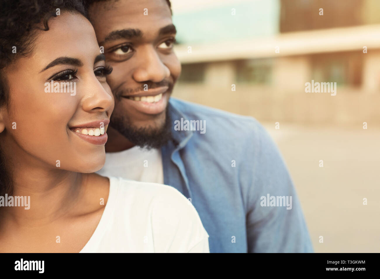 Happy couple looking aside, walking in city Stock Photo - Alamy