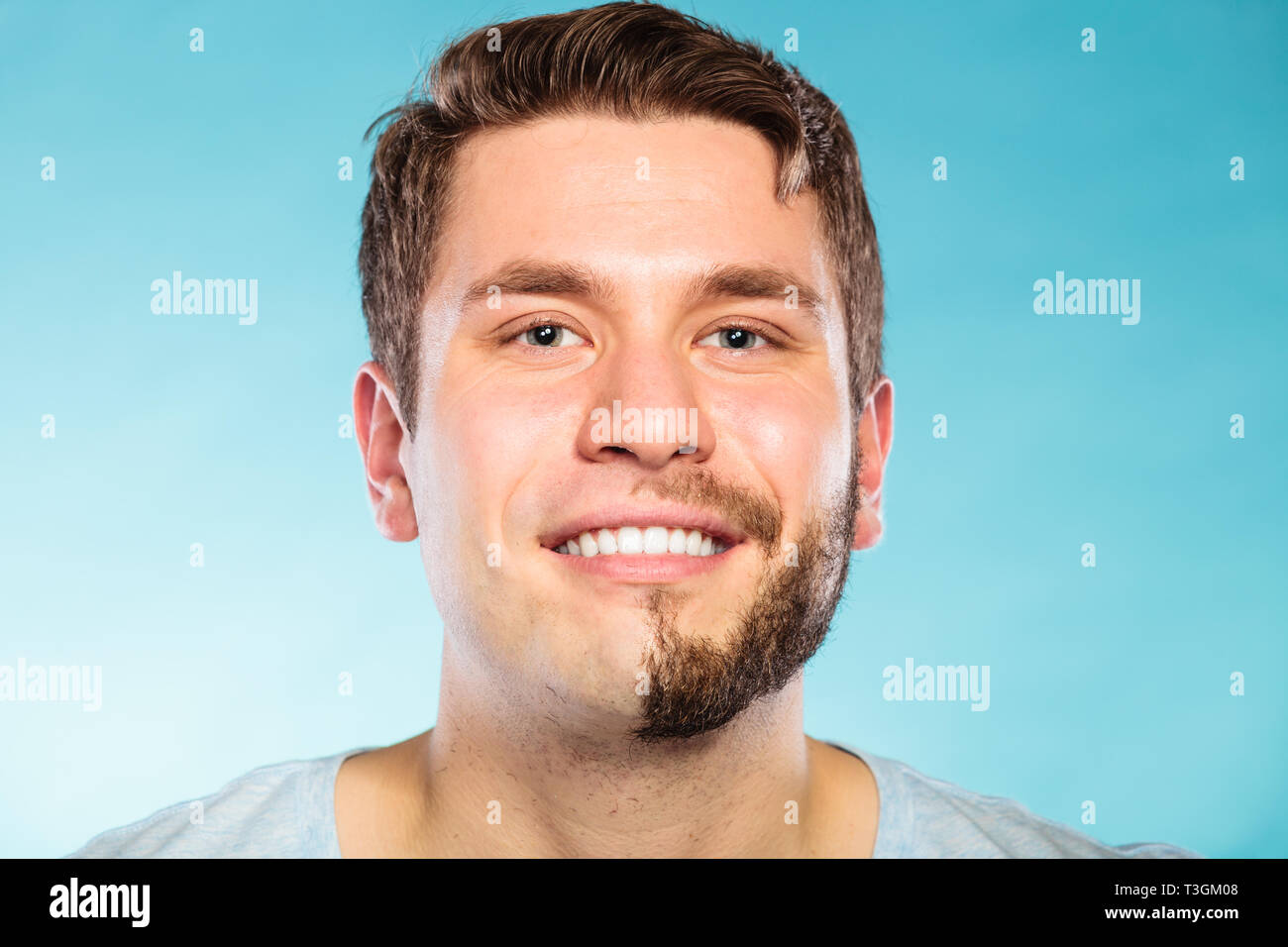 Portrait of happy man with half shaved face beard hair. Smiling ...
