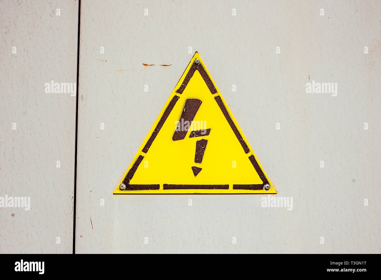Yellow sign danger electricity on steel door in switchboard. Texture ...