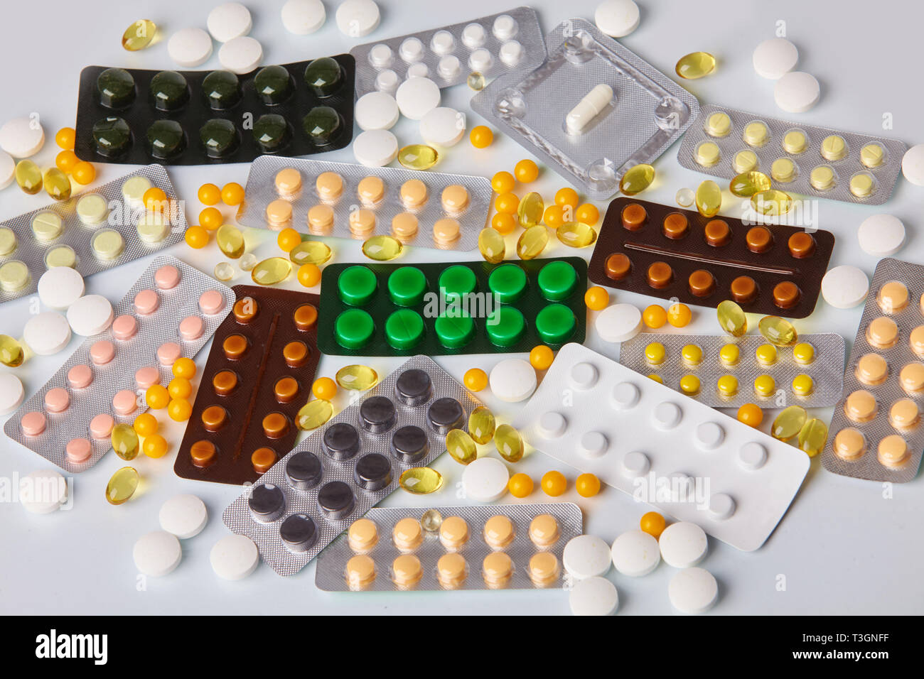 Different colorful packs of pills and tablets on white background ...