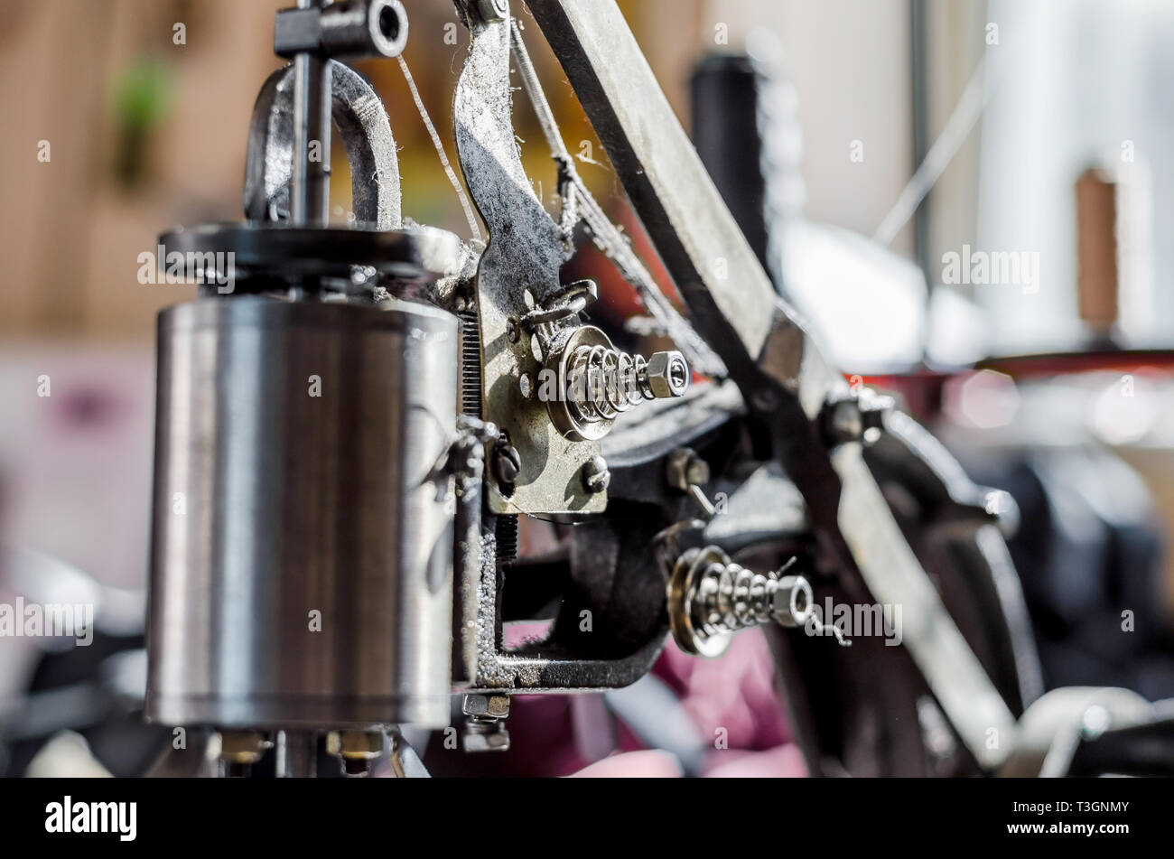 Part of the mechanism is a vintage sewing machine, a supper, a guiding ...
