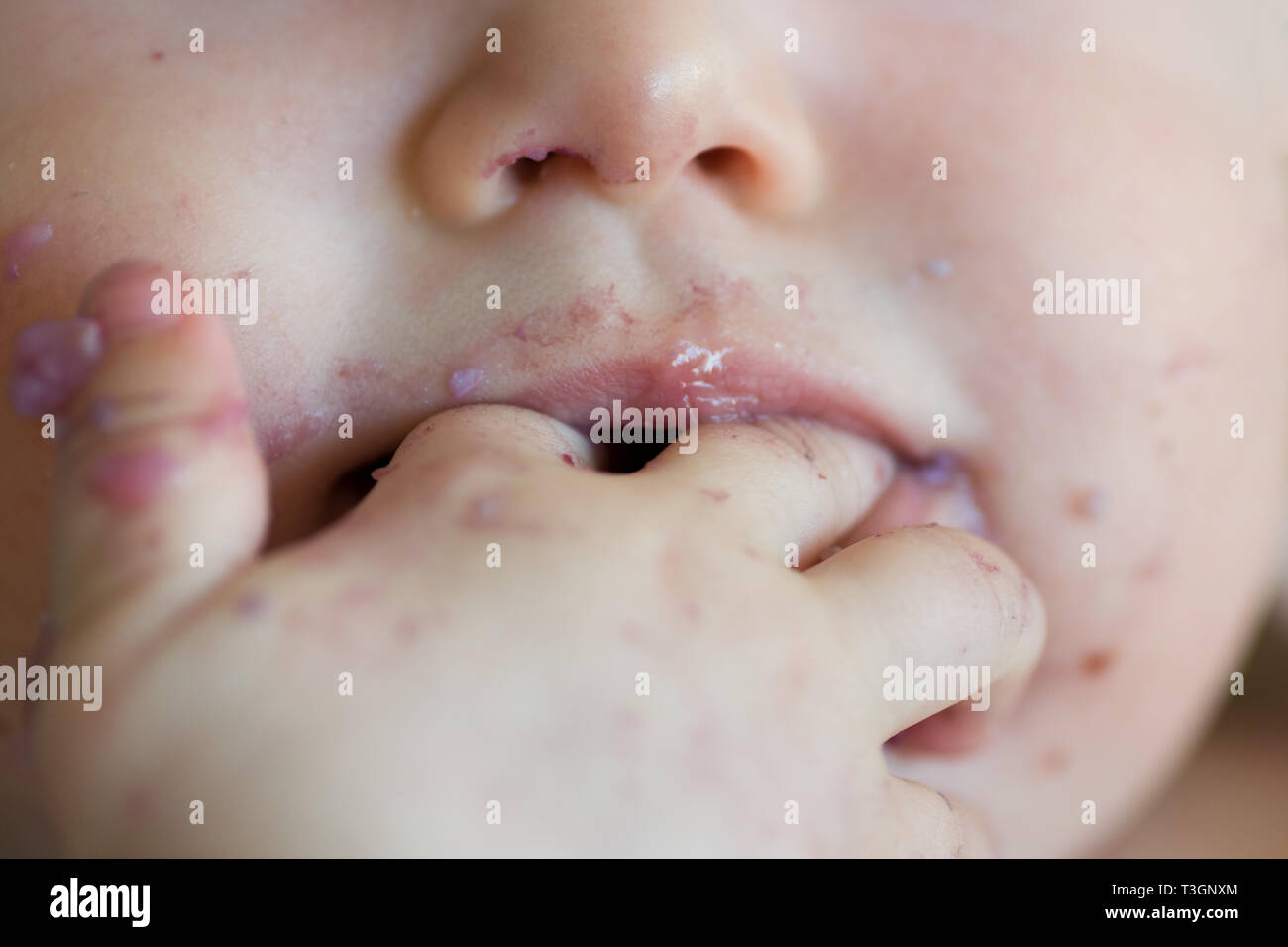 Baby eating with hands, face besmeared with food, defocused image Stock ...