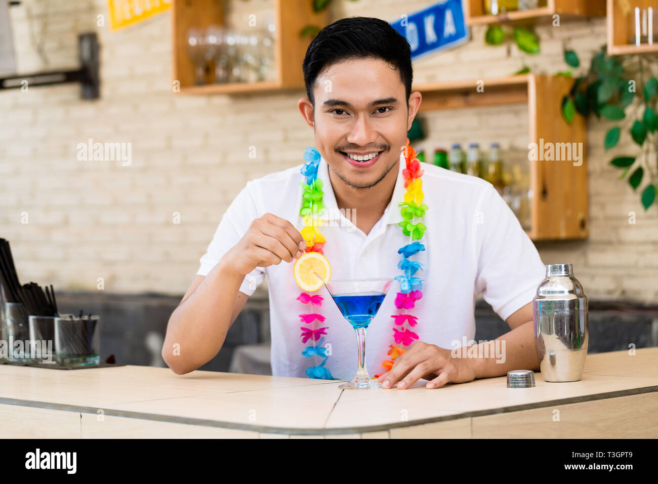 Man with blue cocktail Stock Photo - Alamy