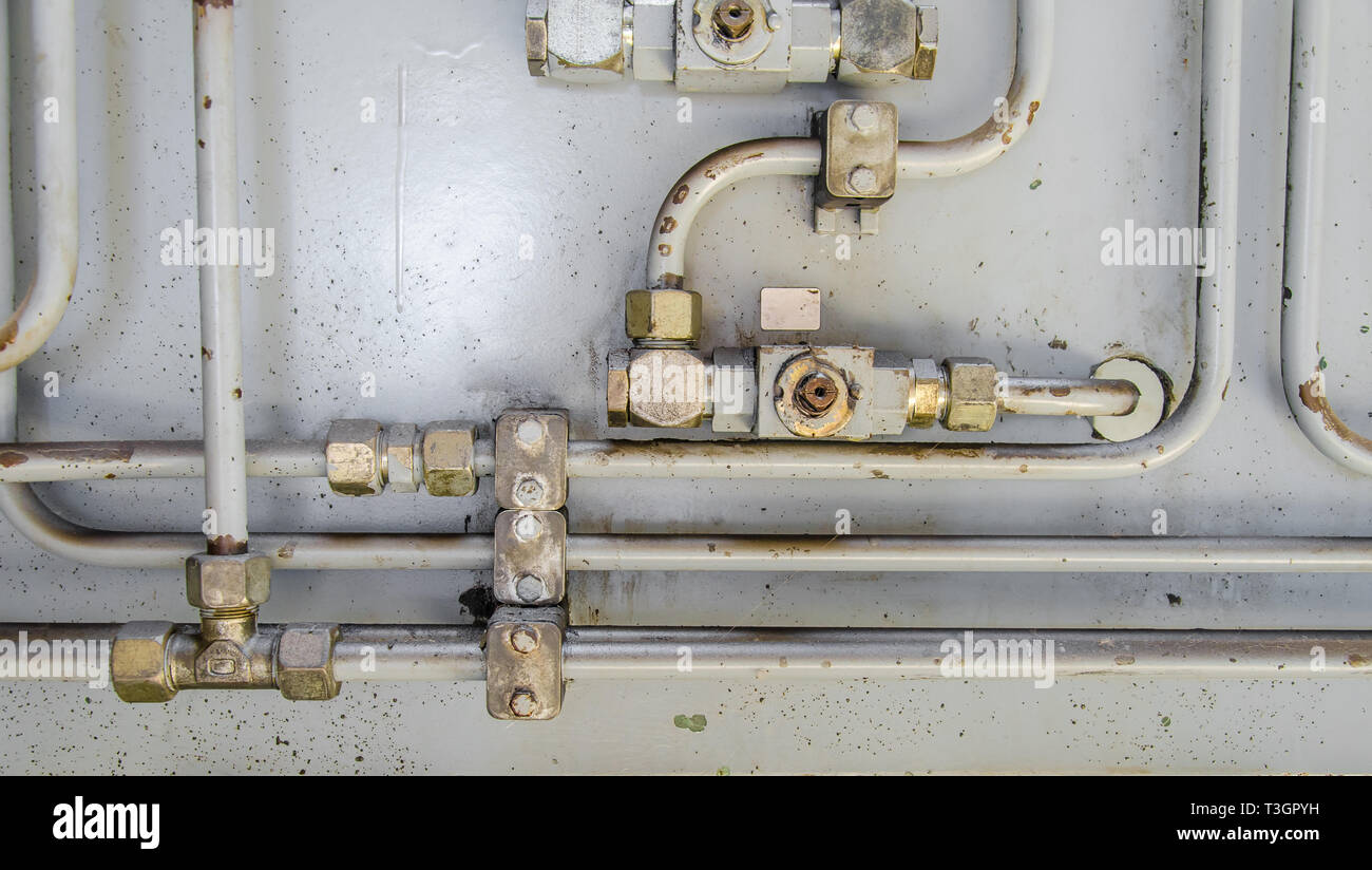 Metallic pipes of gray color on the machine-compressor. Pneumatic ...