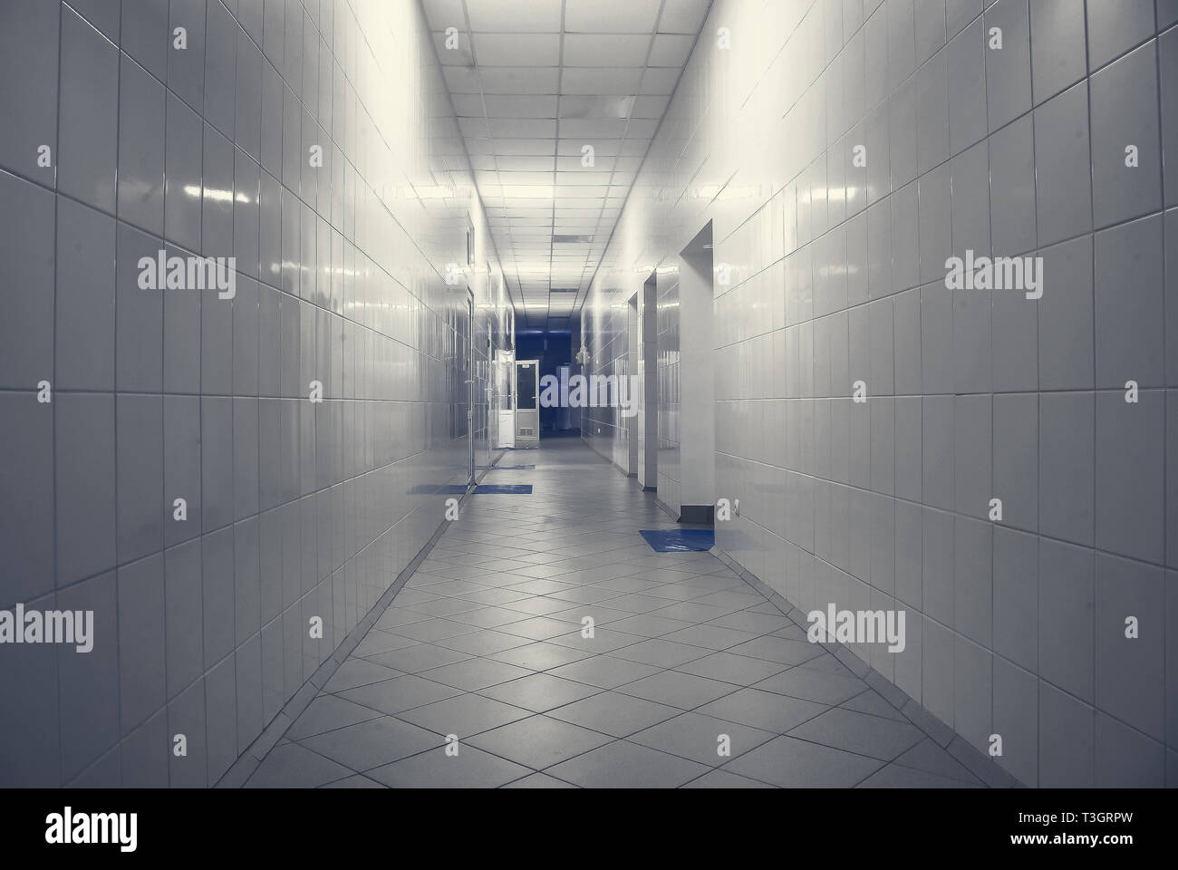 Long corridor with white tiles industrial factory Stock Photo - Alamy