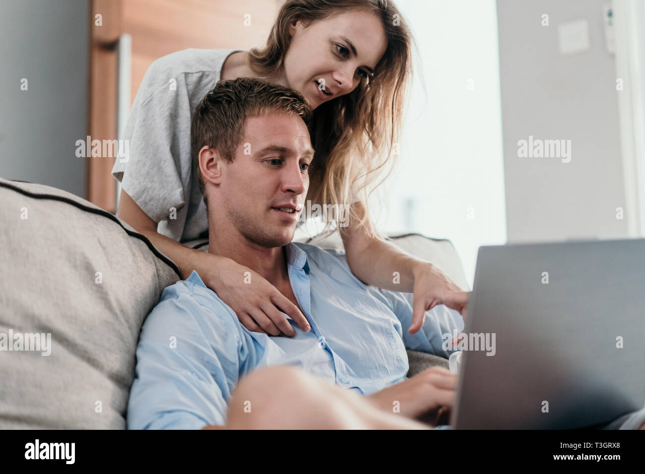 couple in their home using laptop together in the morning Stock Photo ...