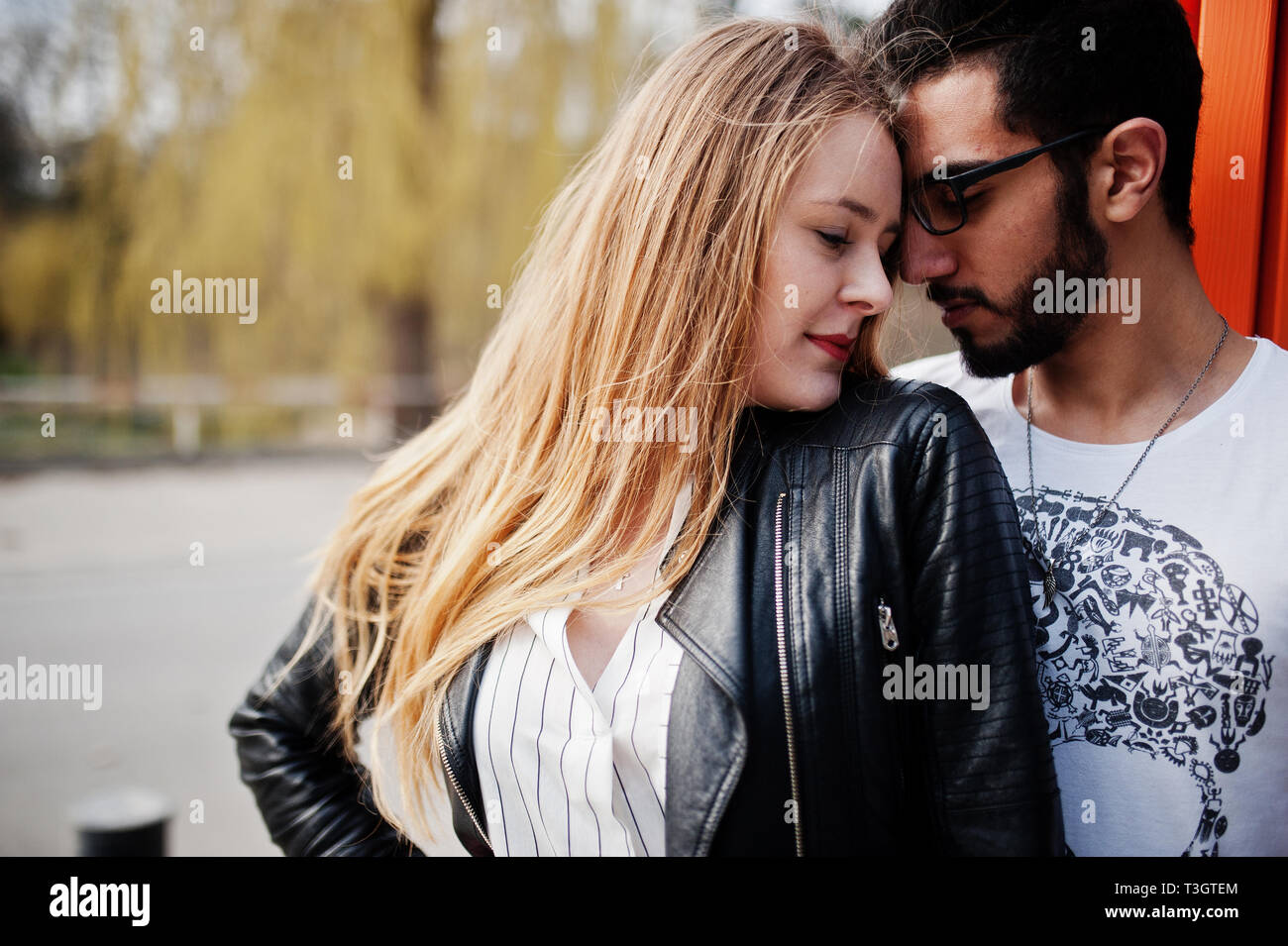 Cool multiracial couple posing and hugs together in love Stock Photo ...