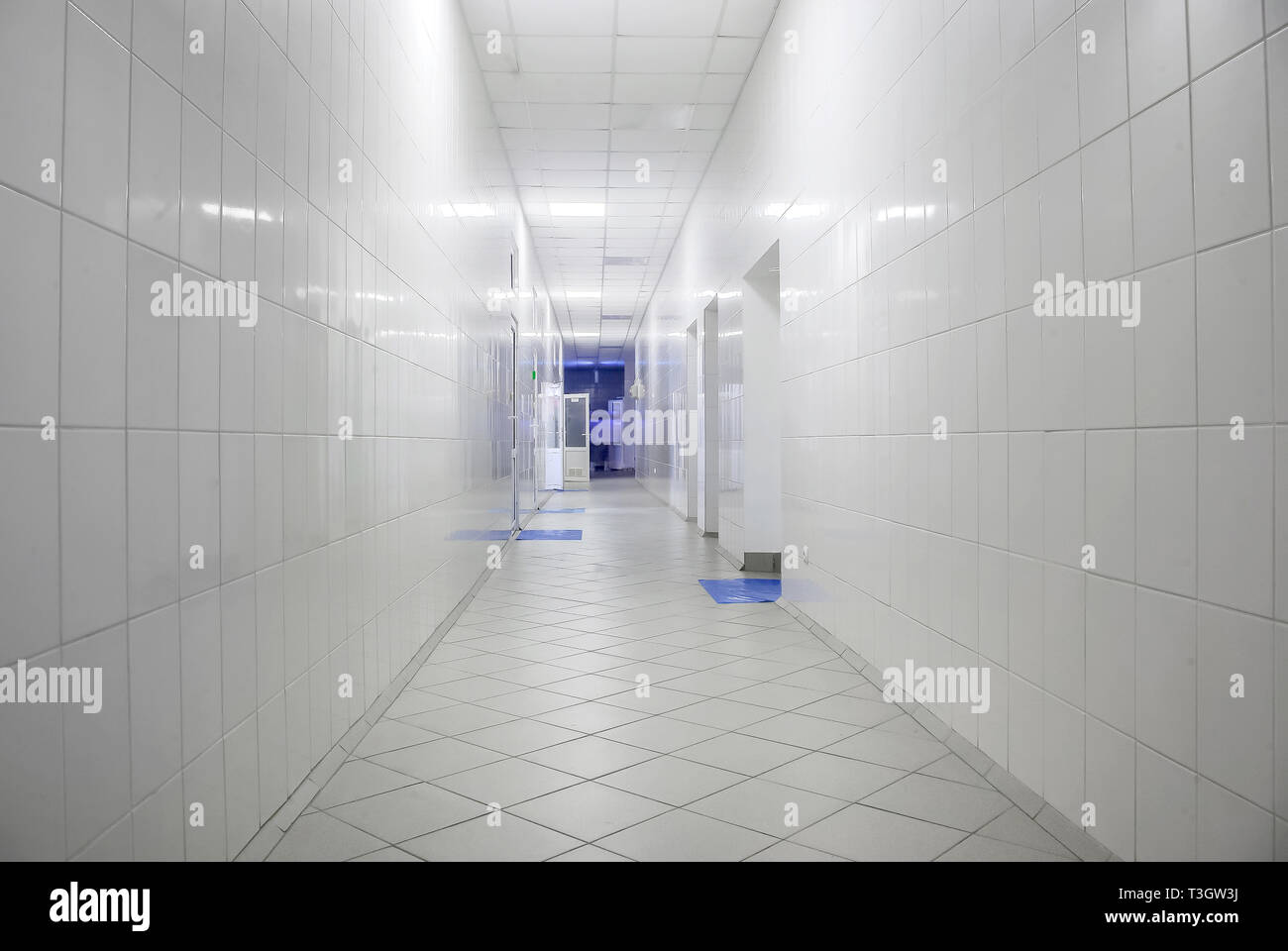 Long corridor with white tiles industrial factory Stock Photo - Alamy