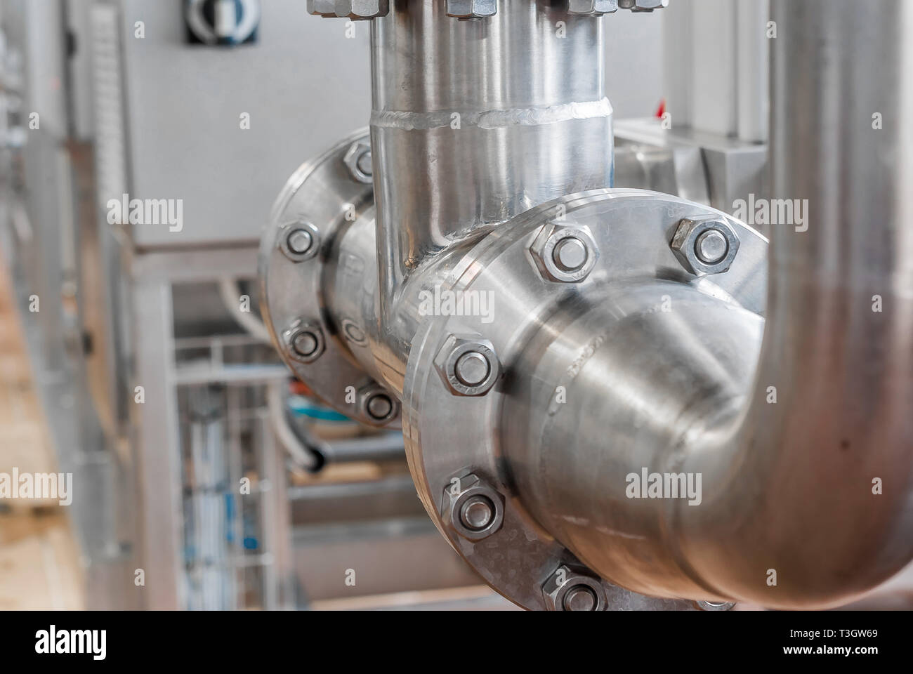 Connection of stainless steel pipes with bolts. Brilliant surfaces ...