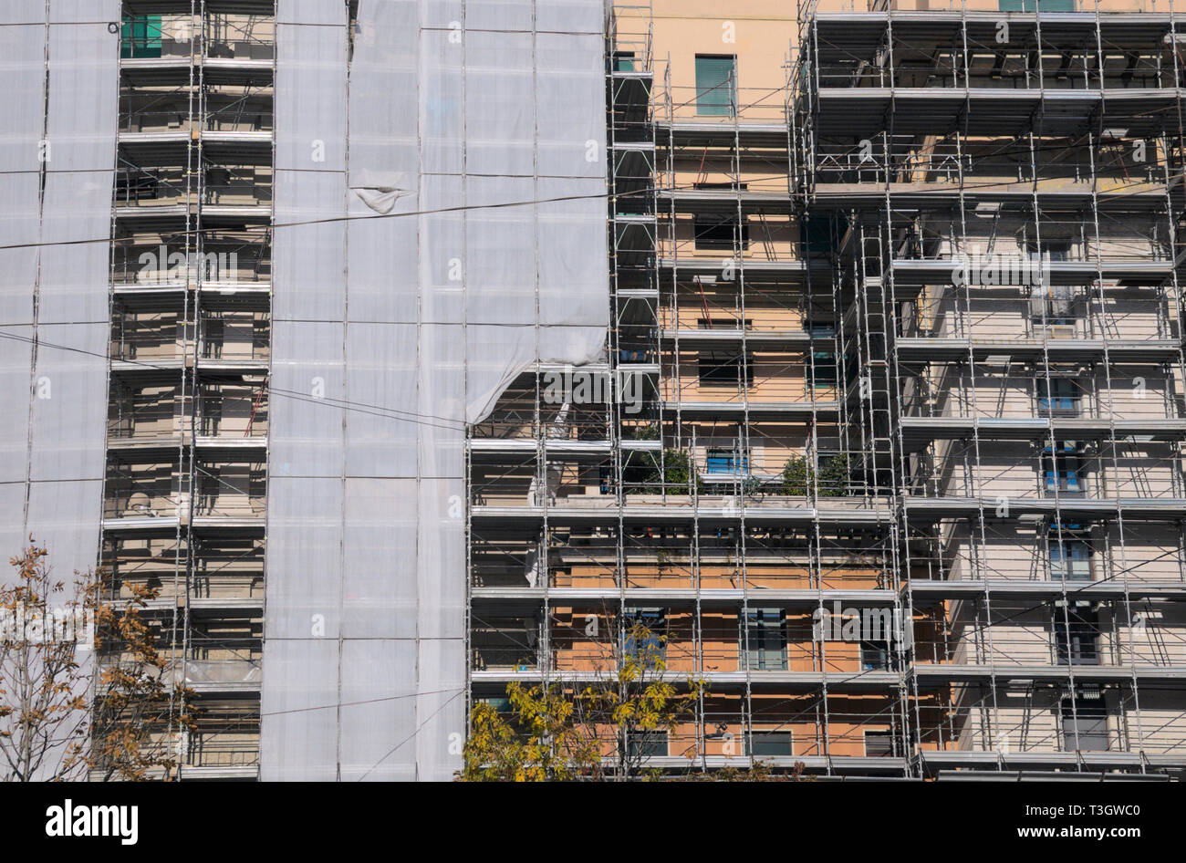 Scaffolding around the residential building for renovation, Milan ...