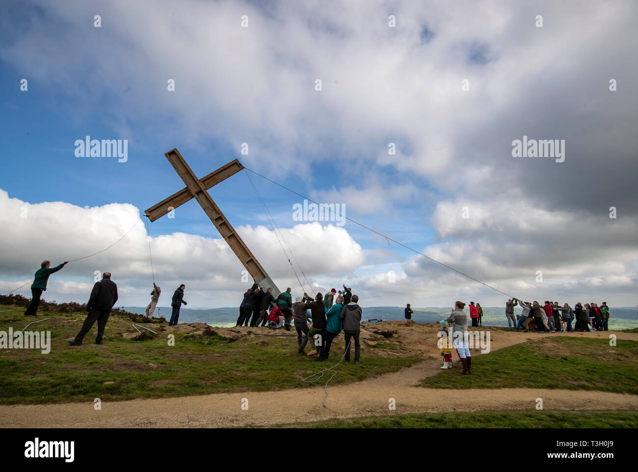Over 50 people install a 36-feet high cross ahead of Easter on Surprise ...