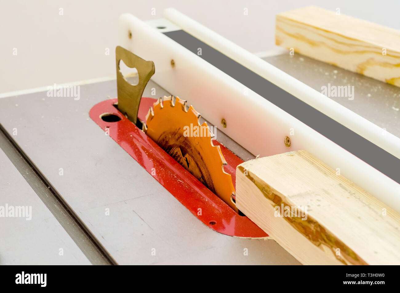Cutting the board on a circular saw in a woodworking workshop Stock ...