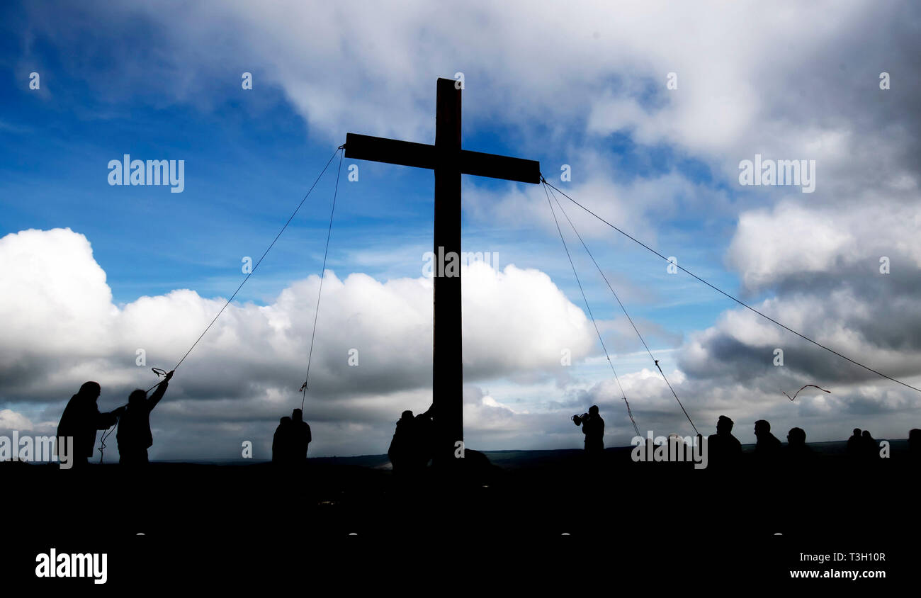 Over 50 people install a 36-feet high cross ahead of Easter on Surprise ...