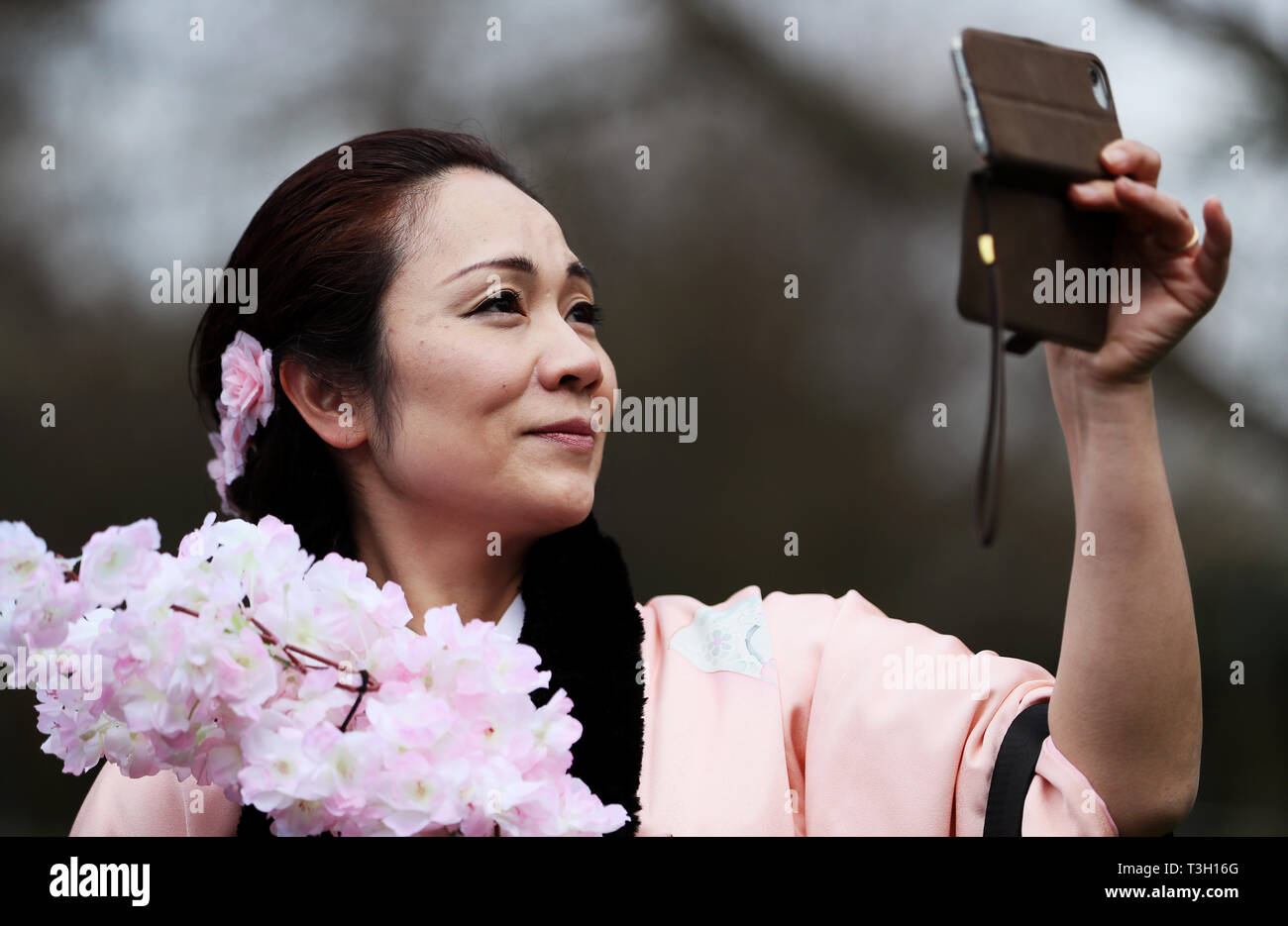 A member of the Odorikko dance group records a performance at the ...