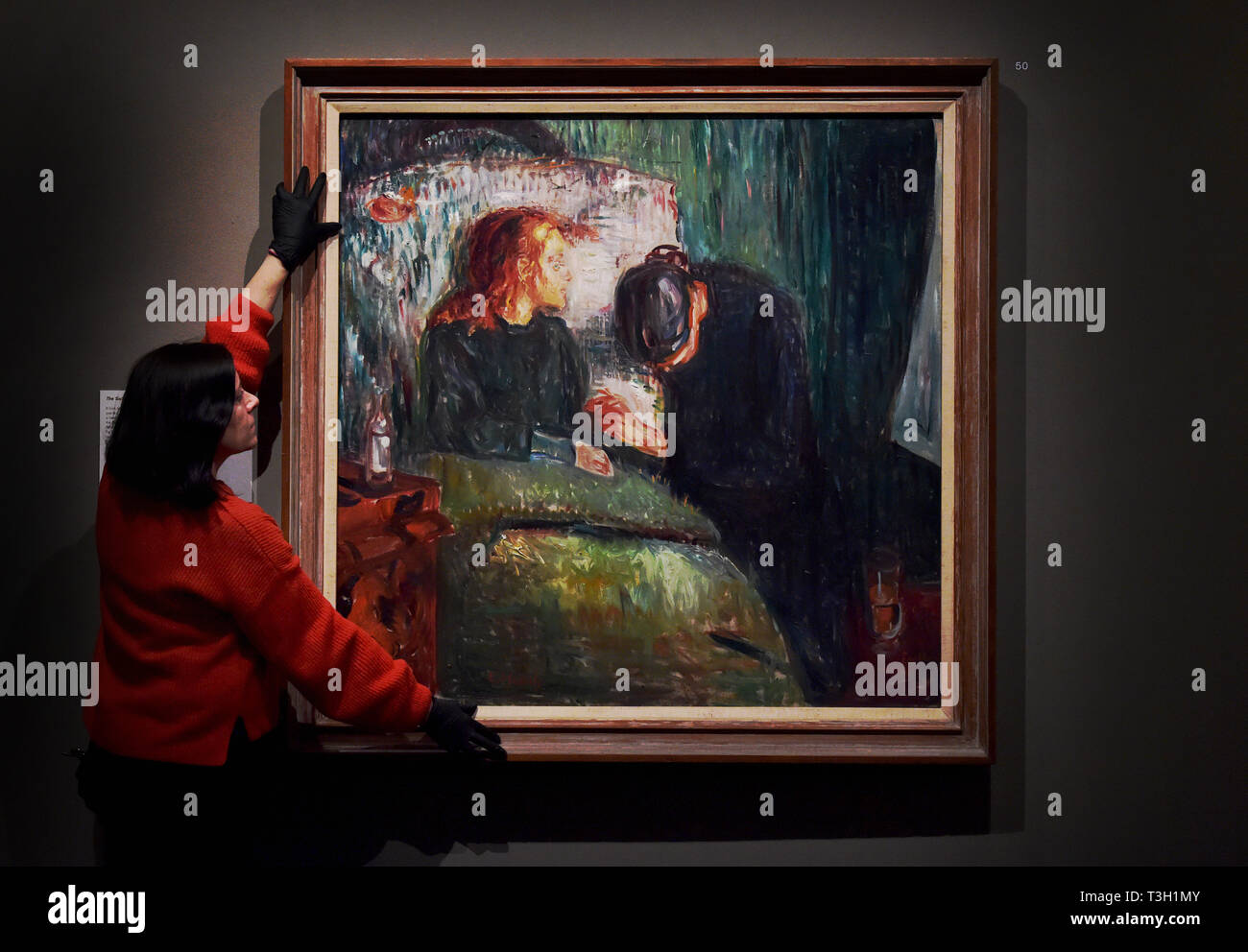 A staff member adjusts The Sick Child (1907) during a preview for the ...