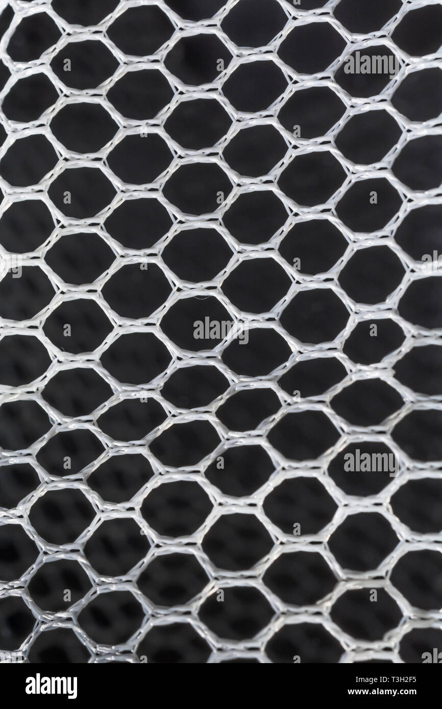 Macro-photo of fine white woven polyester mesh / netting against black ...