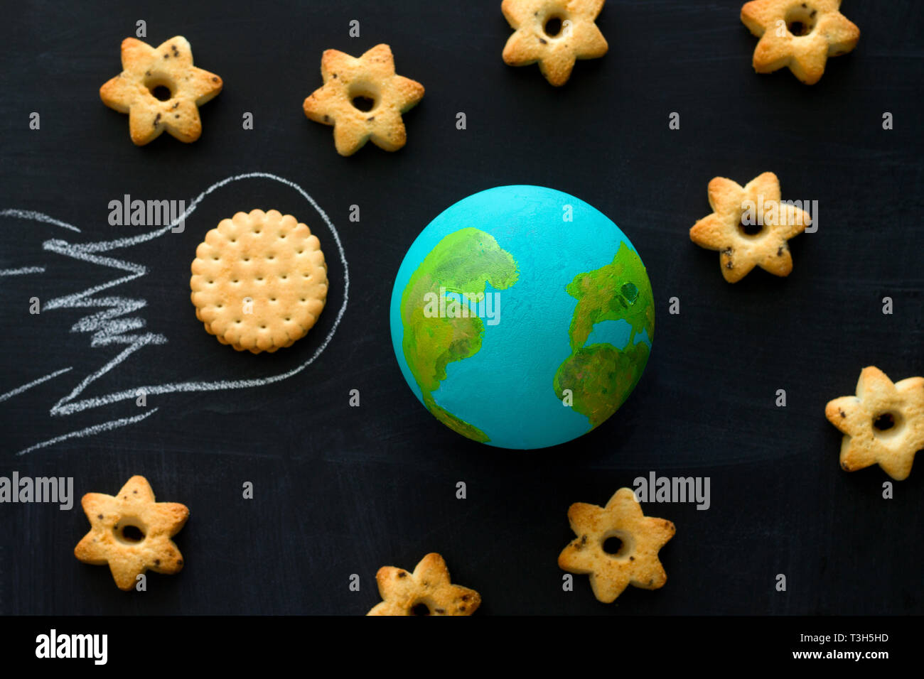 top view handmade model of Earth planet, cookie meteorite and cookies ...