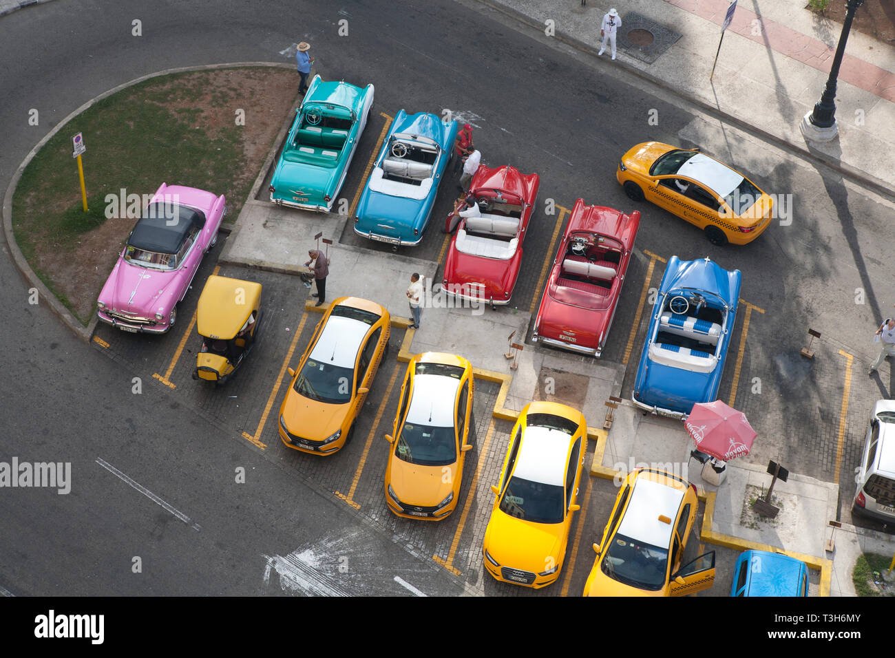 Looking down on brightly coloured cars parked in street in Havana Cuba ...