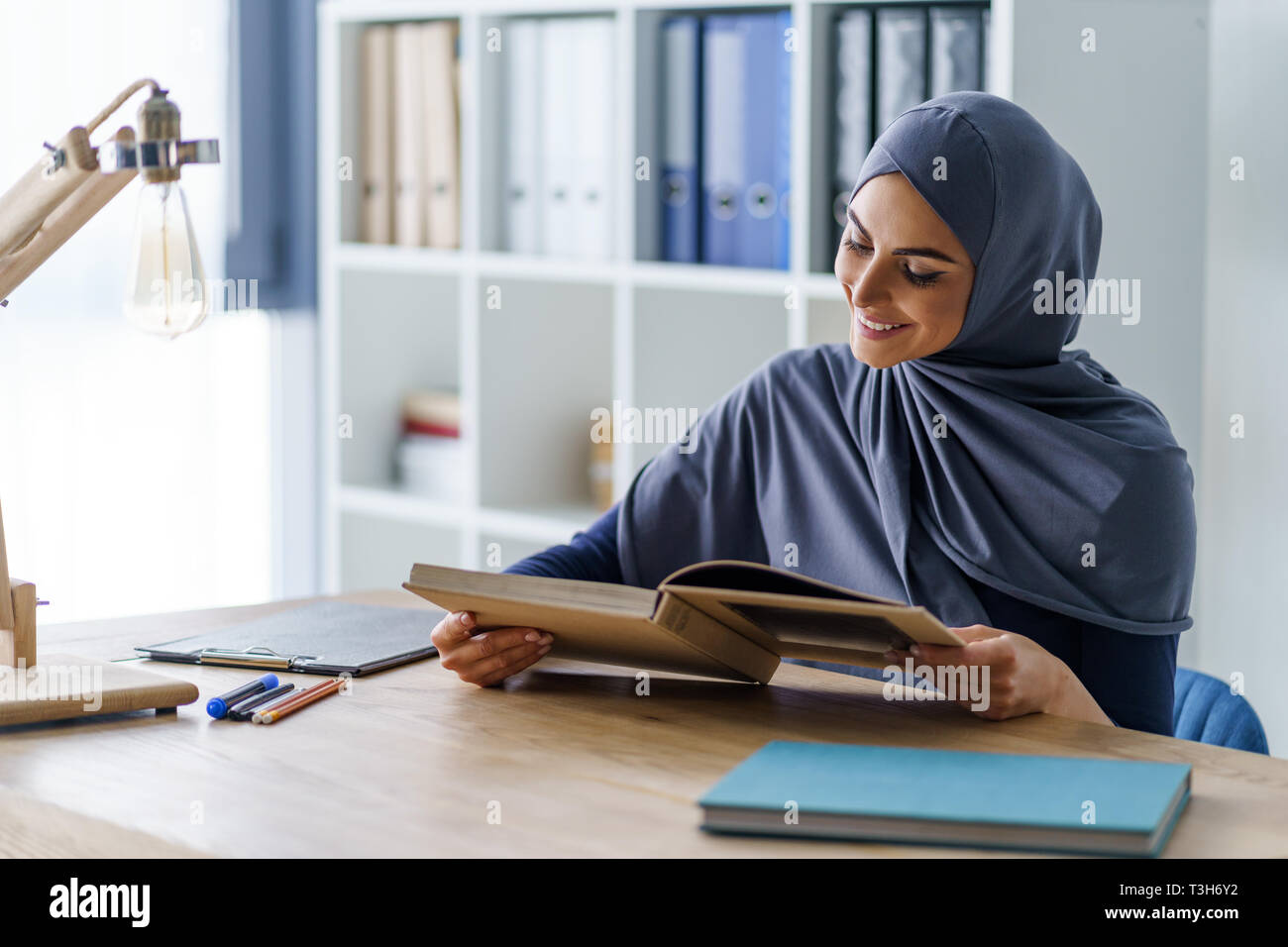 Positive woman absorbed in reading Stock Photo - Alamy